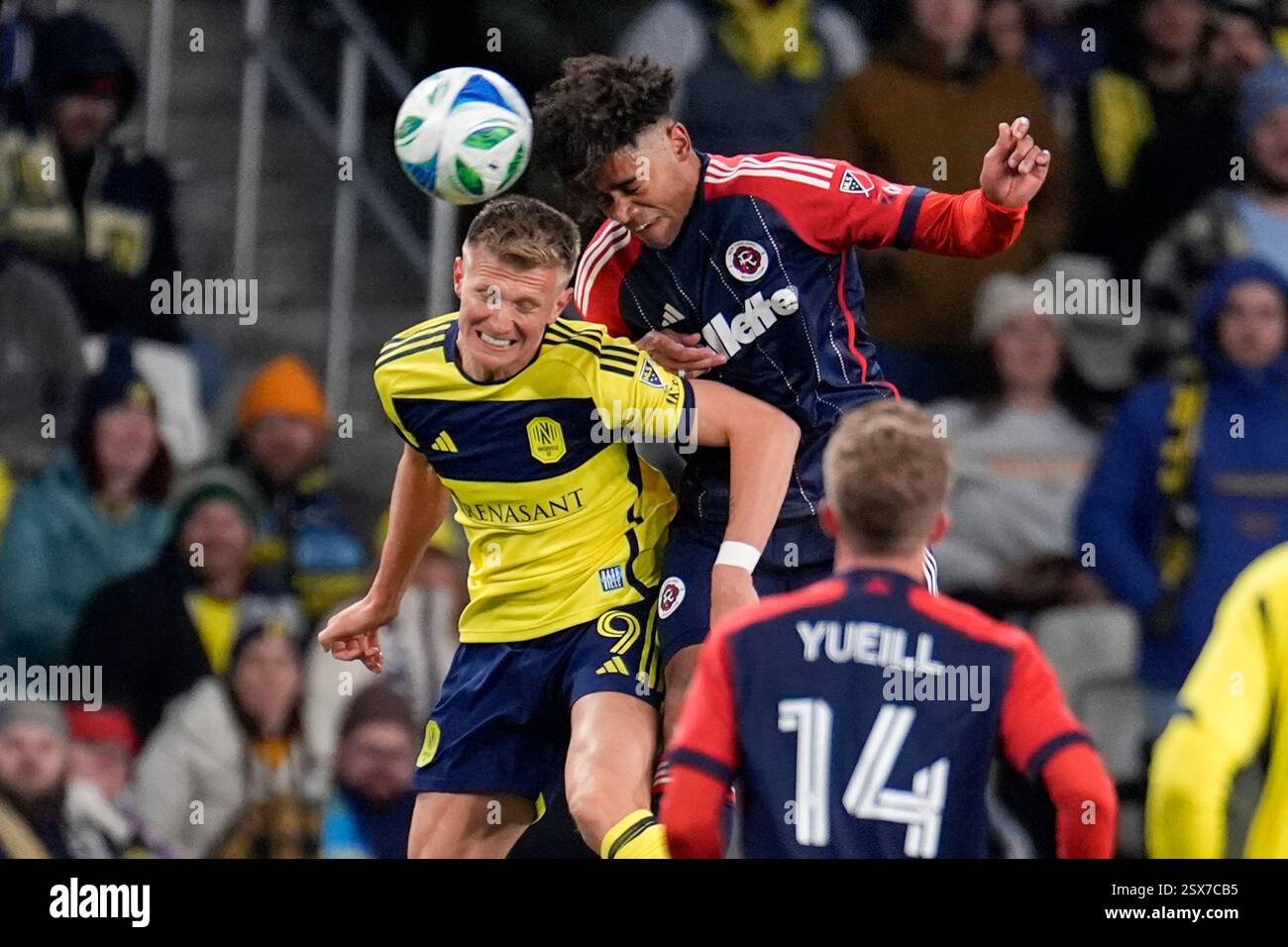 New England Revolution defender Brandon Bye, right, heads the ball over ...
