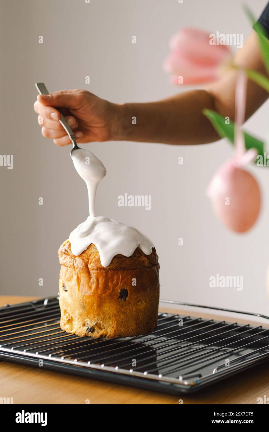 Baking a festive easter panettone with icing on a kitchen countertop ...