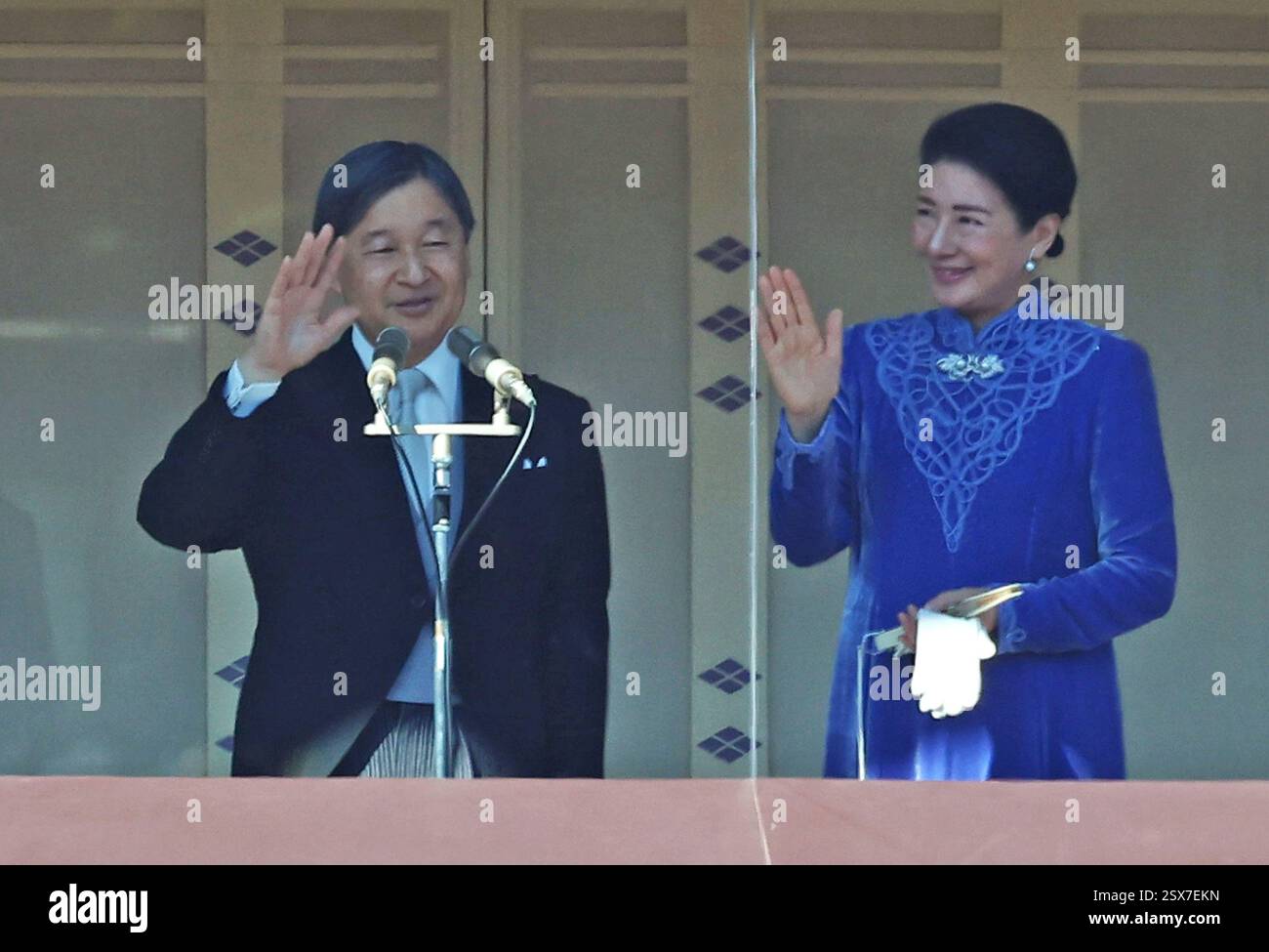 Japanese Emperor Naruhito and Empress Masako wave to the gathered crowd ...