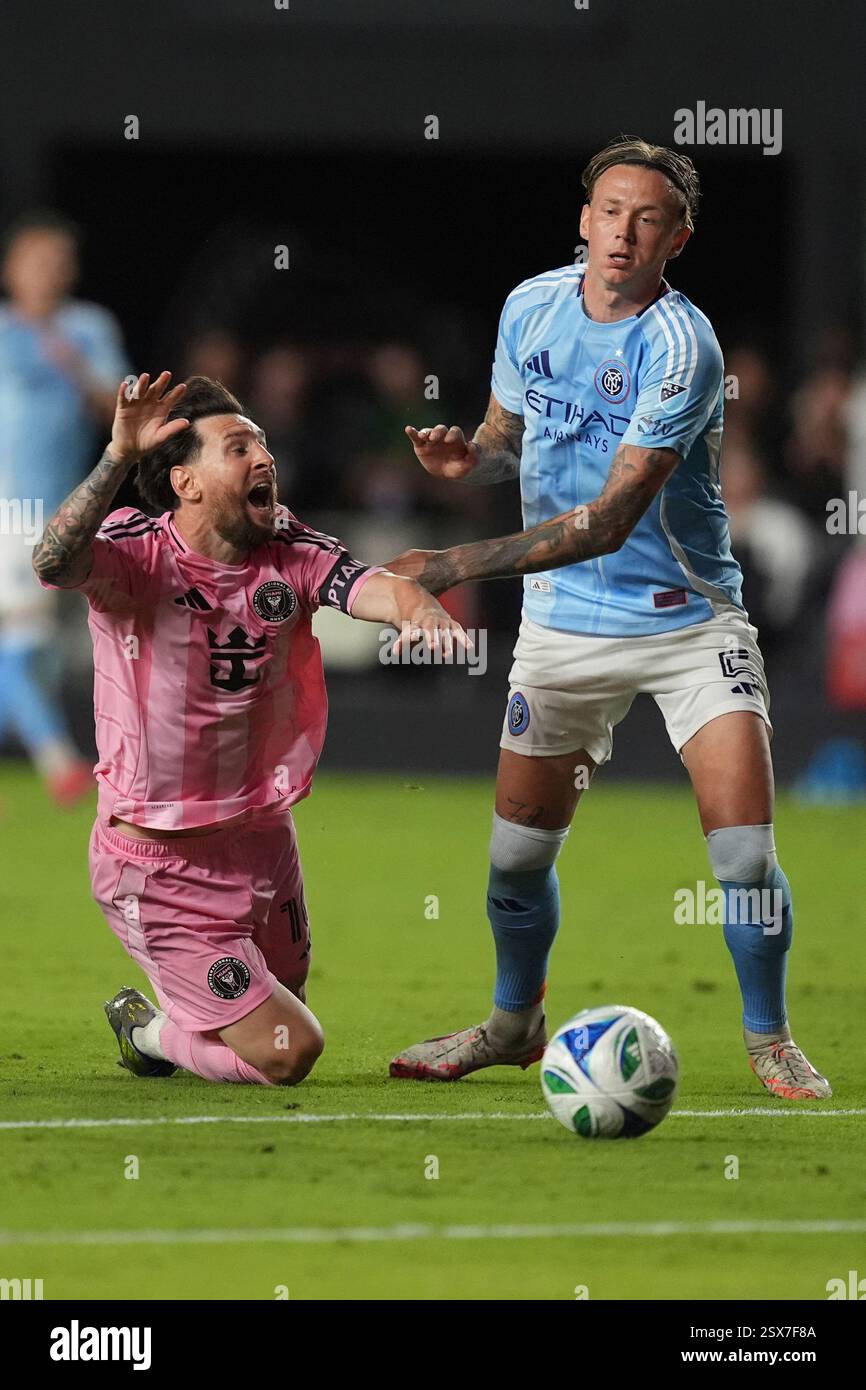Inter Miami forward Lionel Messi is brought down in a tussle with New ...