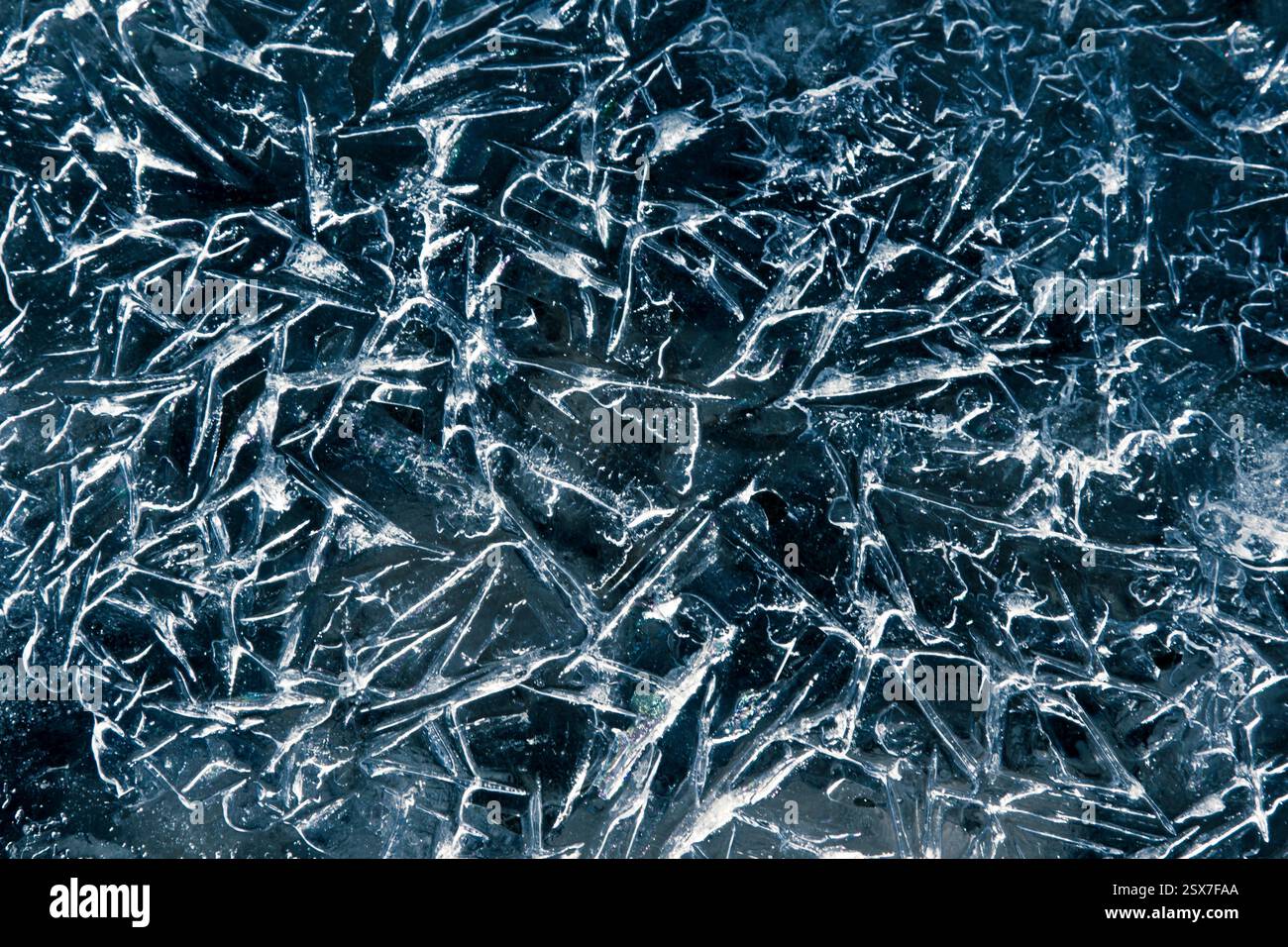 The image is of ice with a blue tint. The ice is jagged and has a rough ...