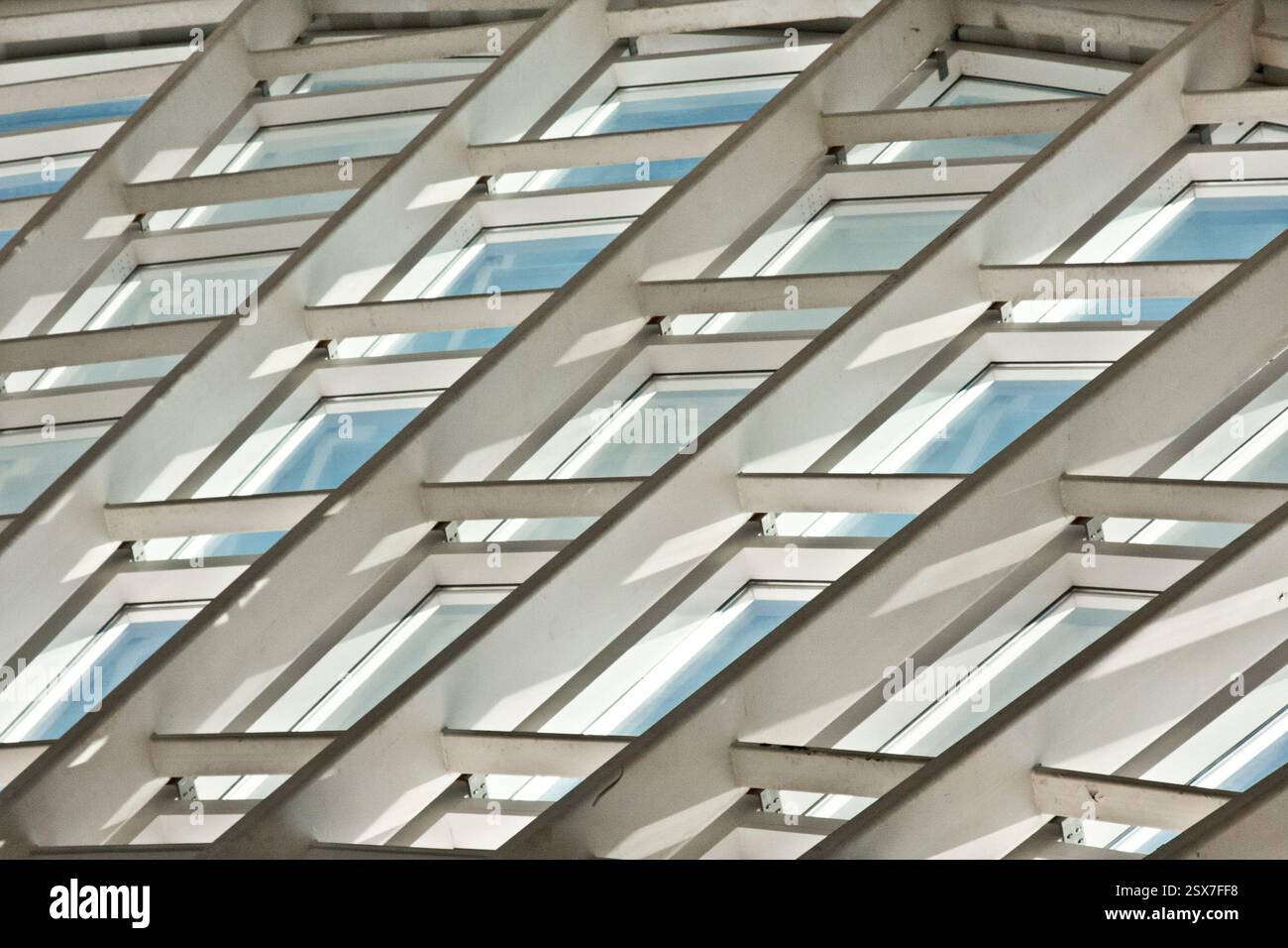 The image is of a building with a lot of windows. The windows are arranged in a grid pattern ...