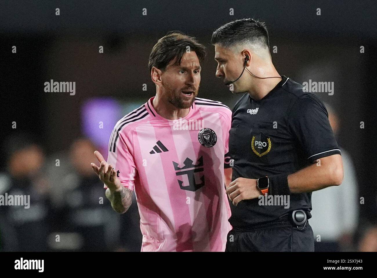 Inter Miami forward Lionel Messi, left, talks with the referee during ...