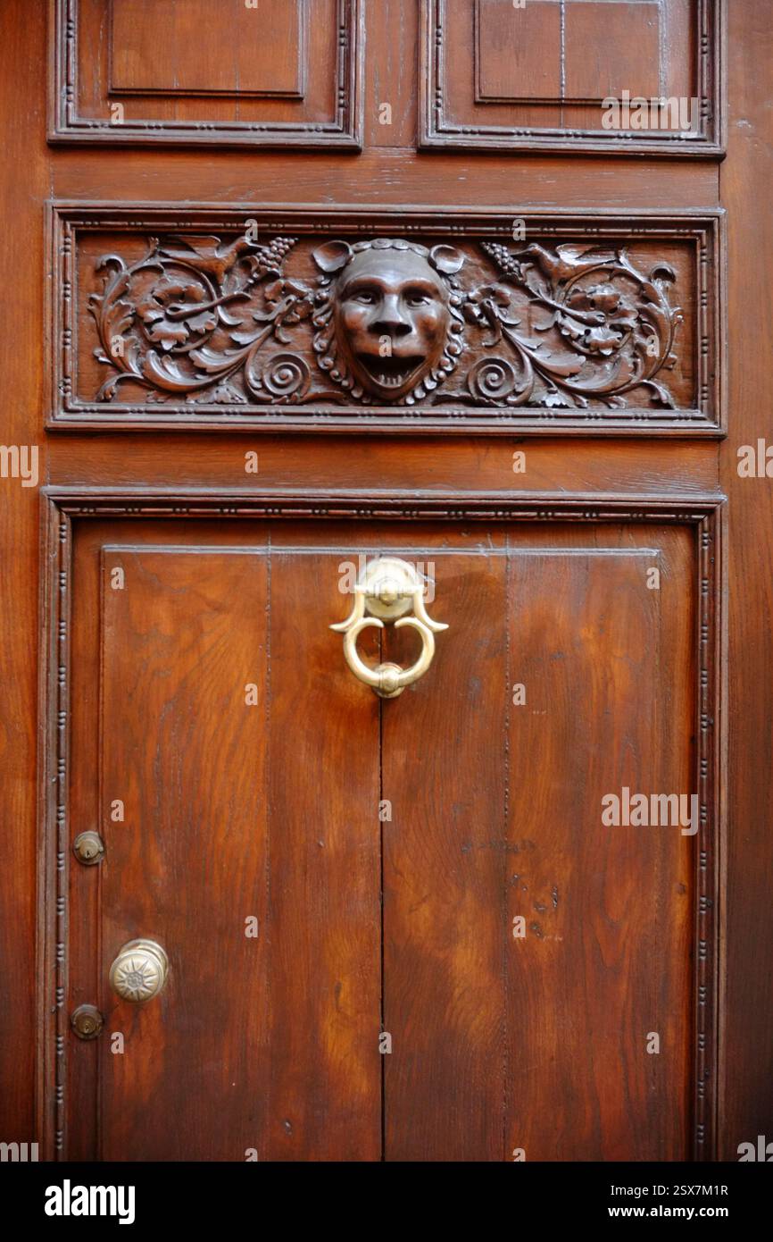 Cremona, Italy February 9th 2025 Old wooden entrance door with lion ...