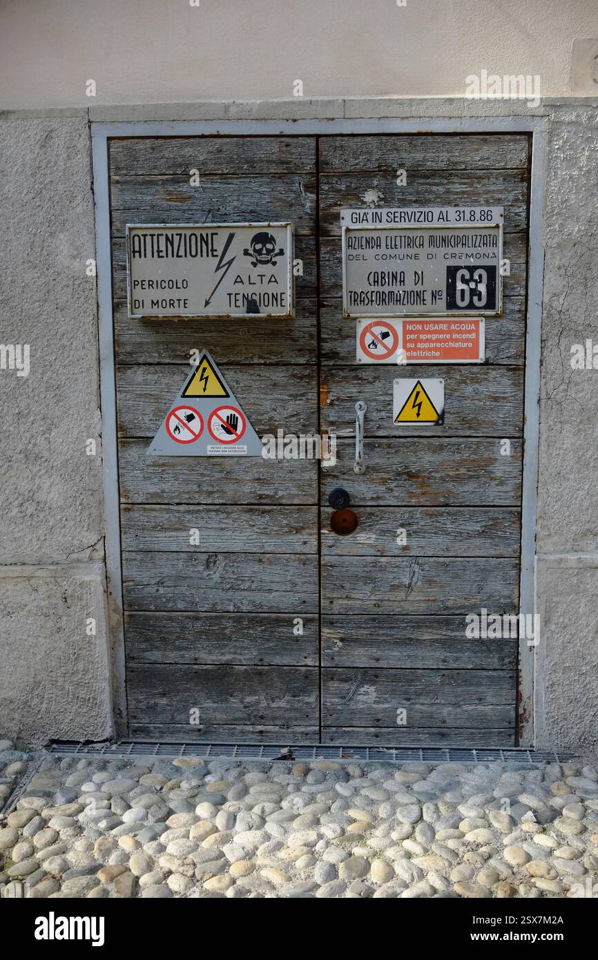 Cremona, Italy February 9th 2025 Weathered wooden door of transformer ...