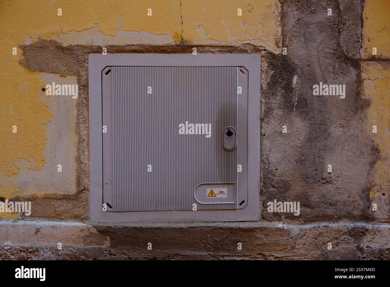 Cremona, Italy February 9th 2025 Gray electrical panel with safety sign ...