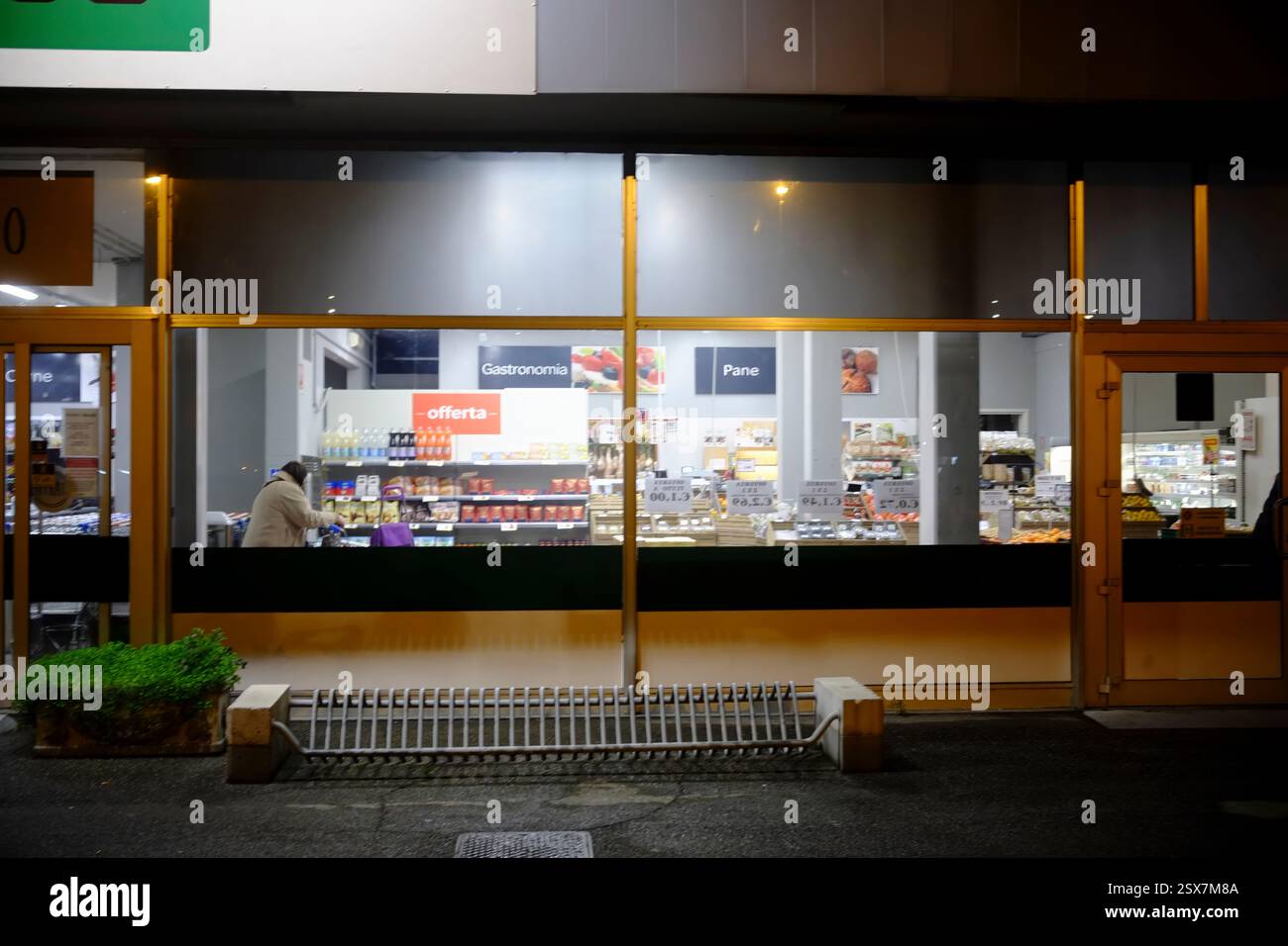 Cremona, Italy February 9th 2025 Illuminated supermarket window ...