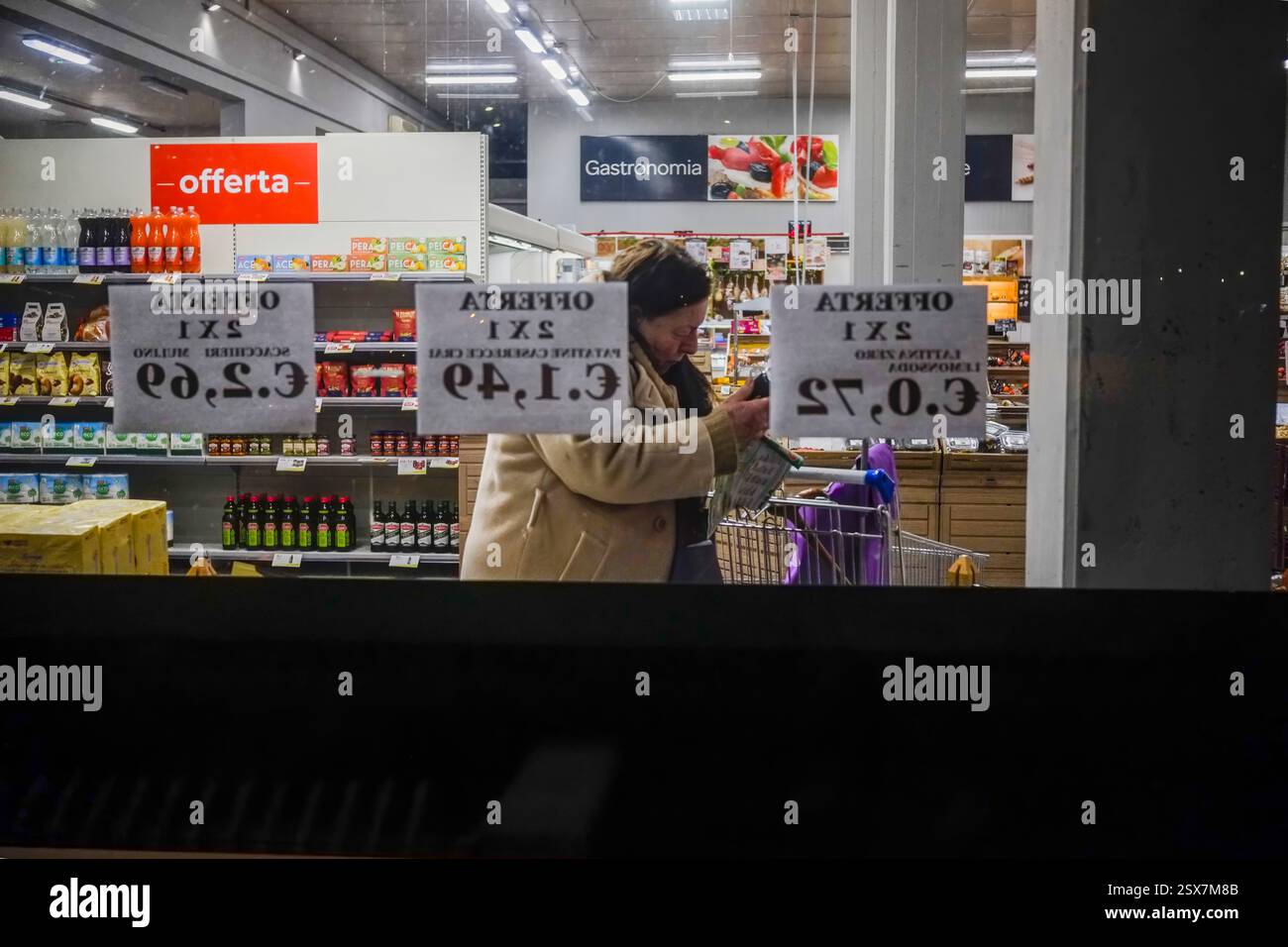 Cremona, Italy February 9th 2025 Elderly woman with shopping cart ...