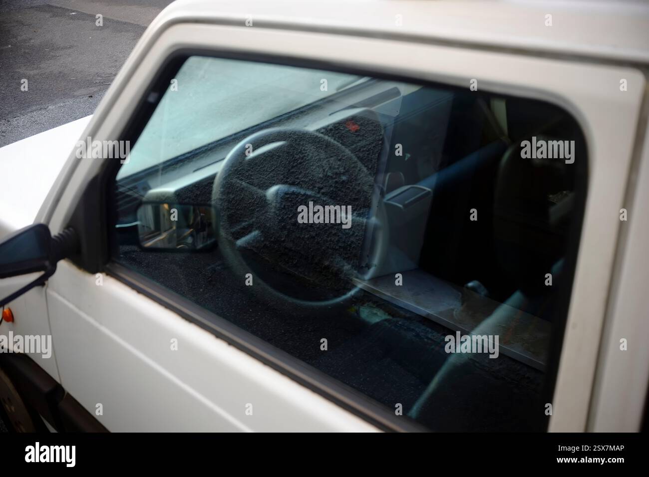 Cremona, Italy February 9th 2025 Steering wheel of a parked white Fiat ...