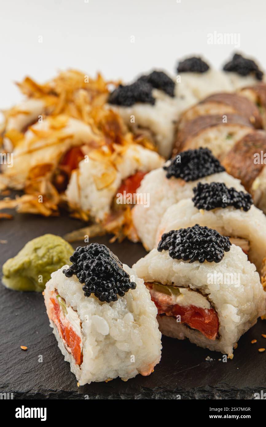 Sushi rolls filled with colorful ingredients are beautifully arranged ...