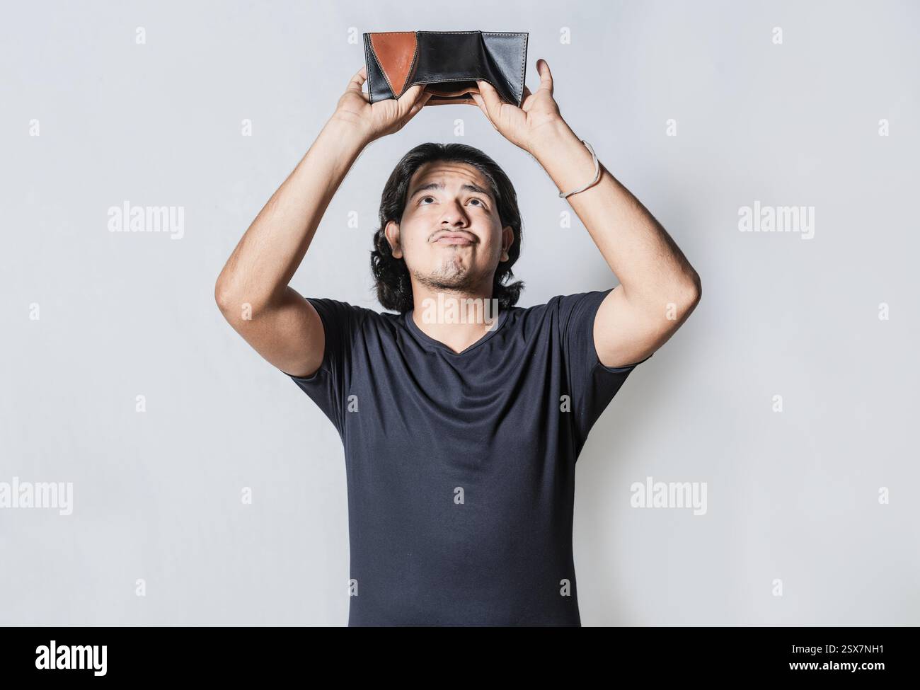 Sad man holding an empty wallet isolated. Unhappy man with financial ...