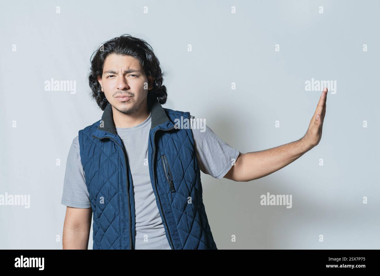 Displeased young man rejecting with palms hands isolated. Upset person ...