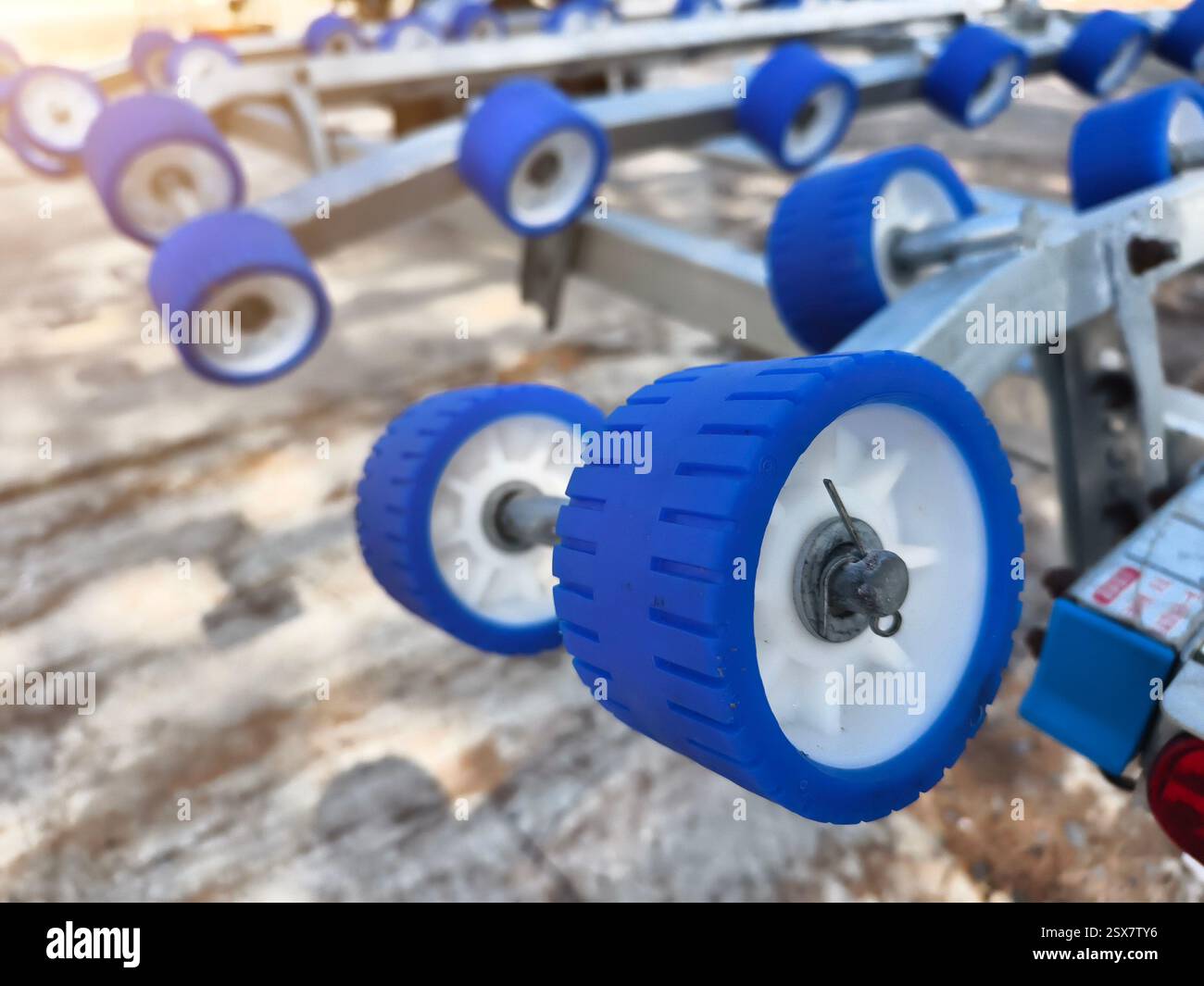 Detailed closeup of a boat trailer that features striking blue wheels ...