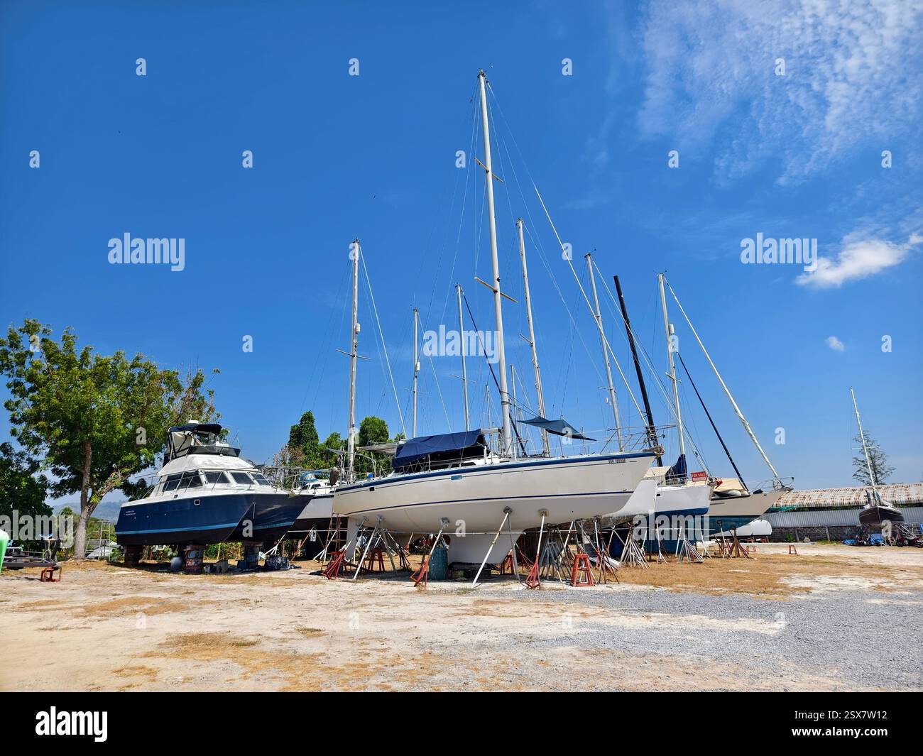 A white voyage boat featuring a steering wheel floating in the dock ...