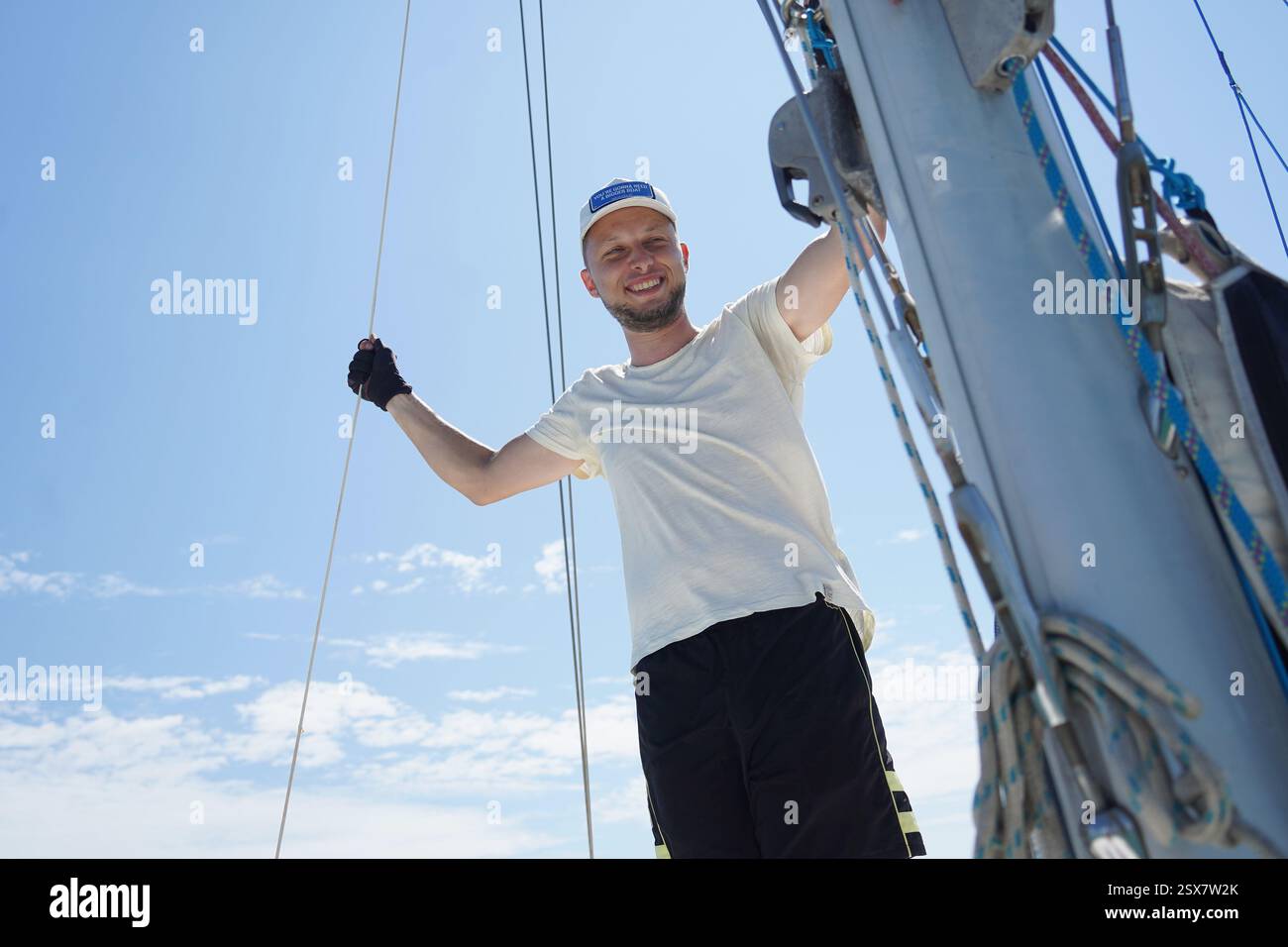 Male captain stands proudly on a sailboat enjoying the moment Stock ...