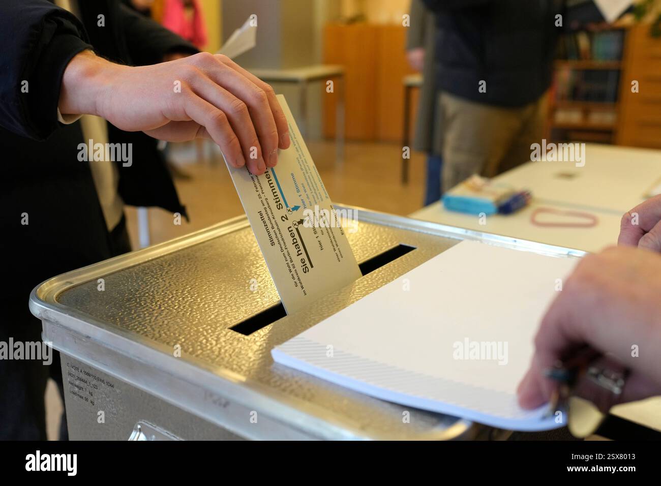 A resident casts a vote at a polling station in Berlin, Germany, Sunday ...