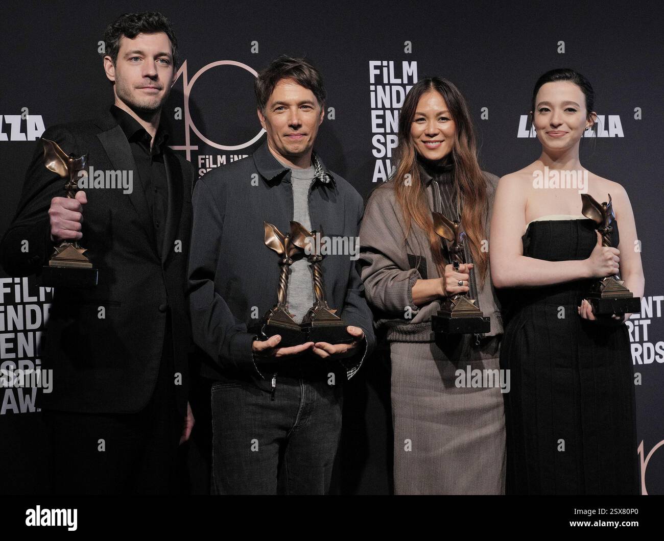 (L-R) Alex Coco, Sean Baker, Samantha Quan and Mikey Madison, winners of the Best Feature award ...
