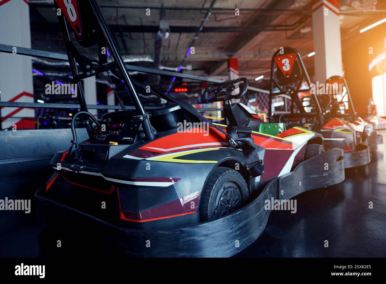 New electric go karts in the modern indoor racing track Stock Photo - Alamy
