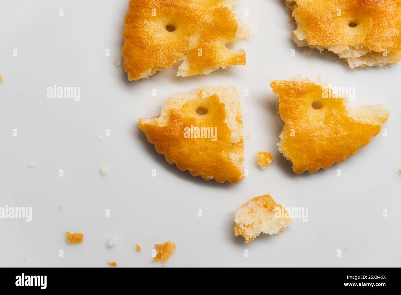 Cracked round crackers on white background Stock Photo - Alamy
