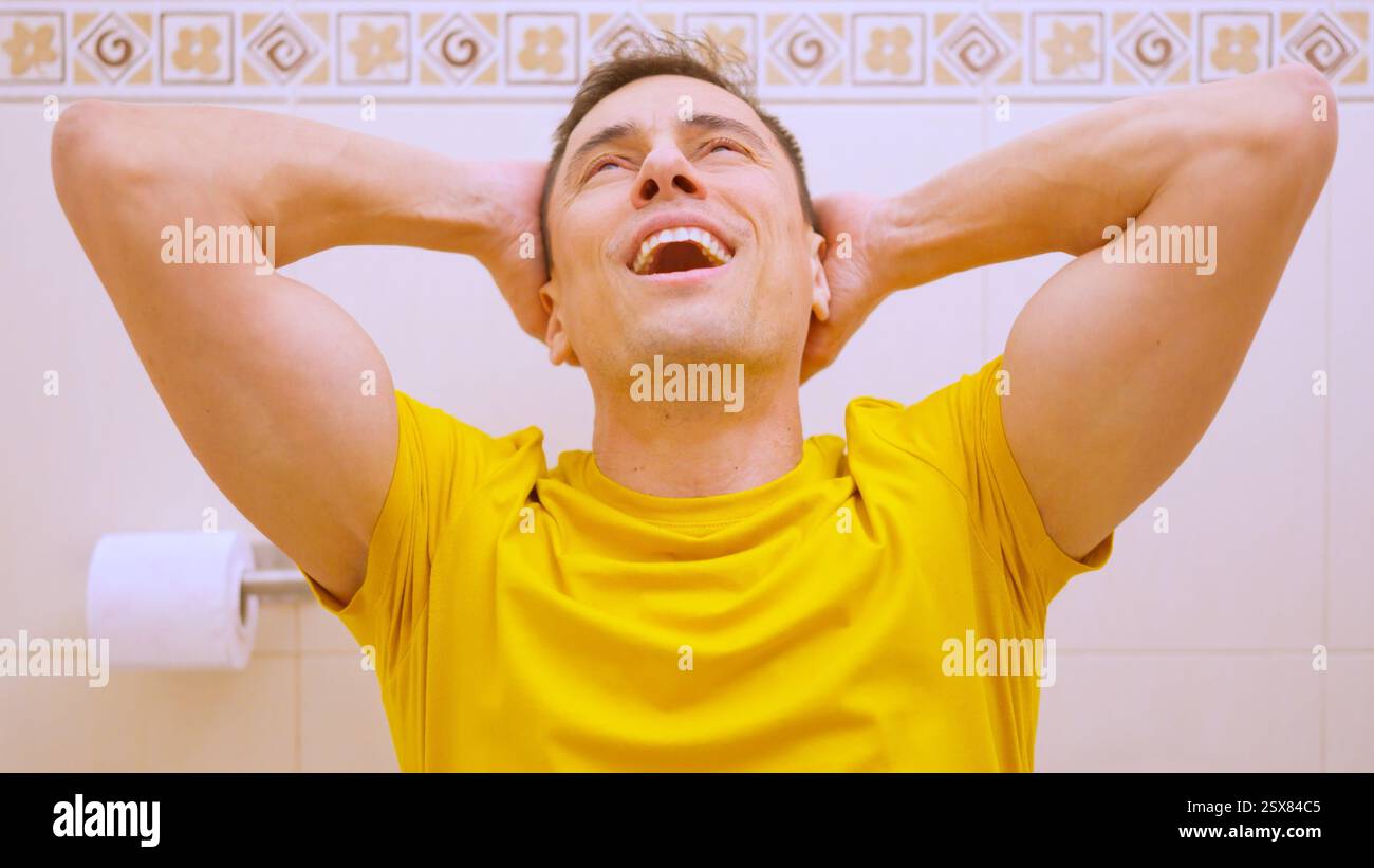 Man feeling relaxed and satisfied on the toilet Stock Photo - Alamy
