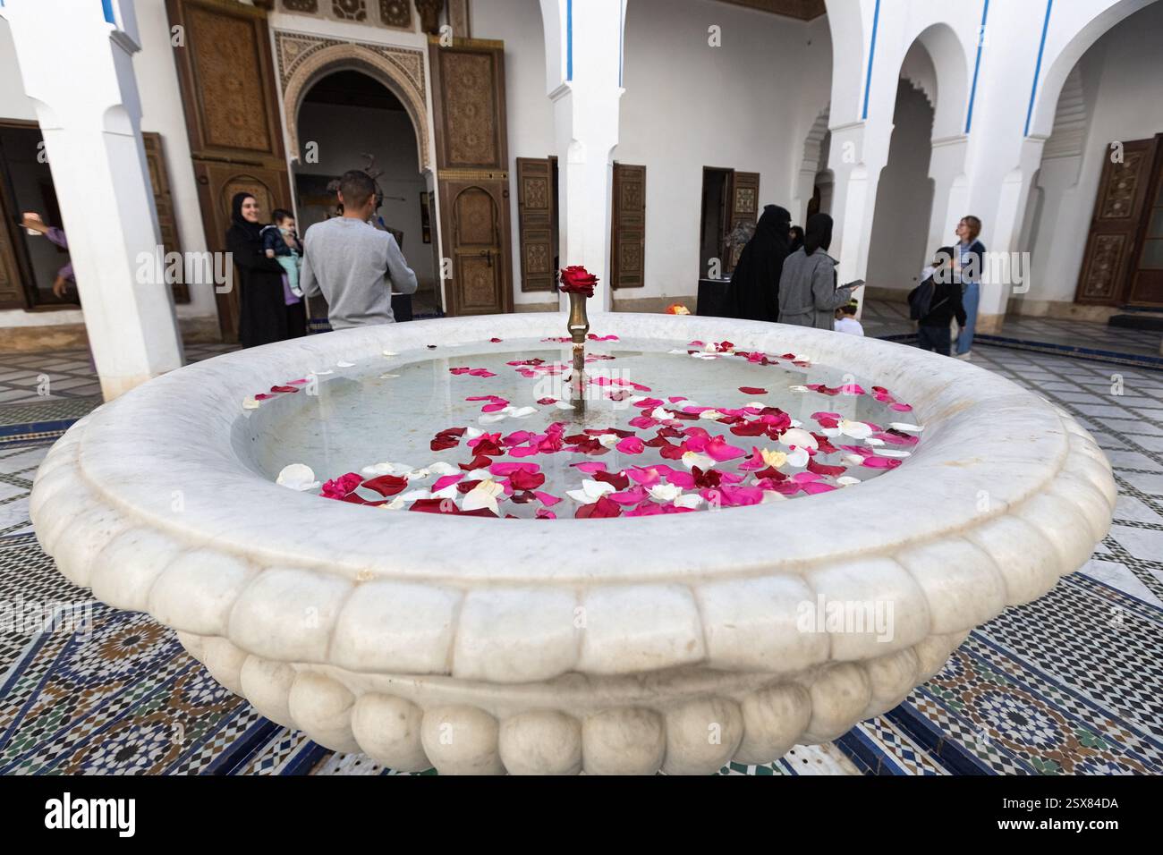 White marble fountain with rose petals in the yard of Bahia Palace in ...