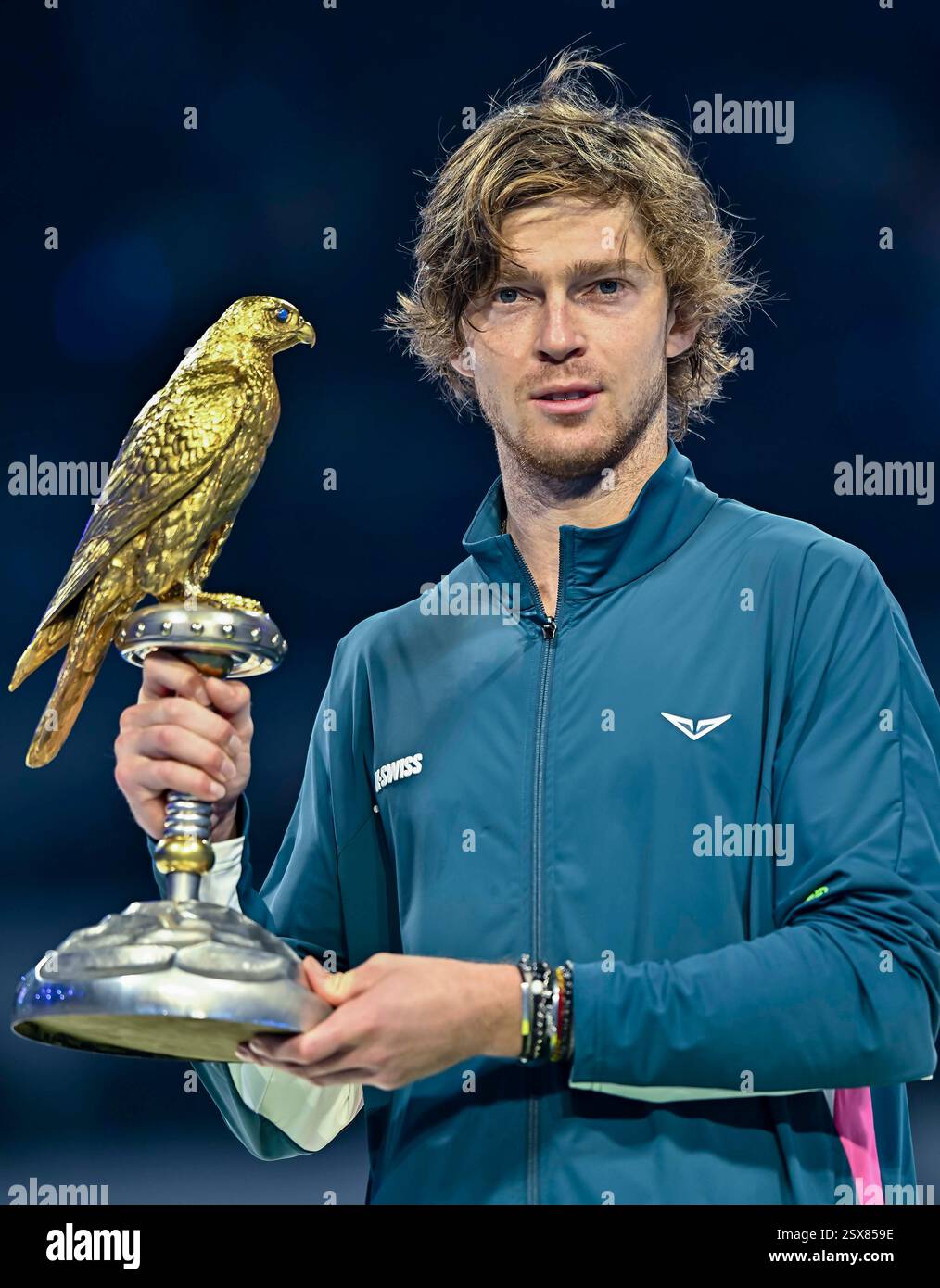 Doha, Qatar. 22nd Feb, 2025. Andrey Rublev poses with the trophy during the awarding ceremony ...