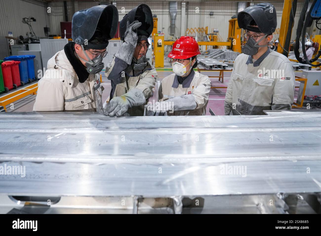 (250223) -- NANJING, Feb. 23, 2025 (Xinhua) -- Sun Jingnan (2nd R) discusses welding techniques ...