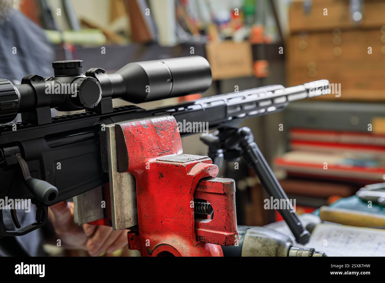 California gunsmith repairs a precision rifle with a scope secured in a ...