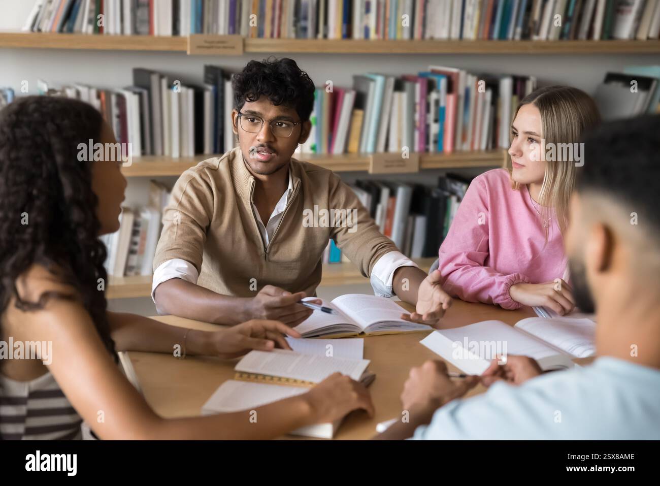 Multiethnic university or high-school students discussing projects and ...