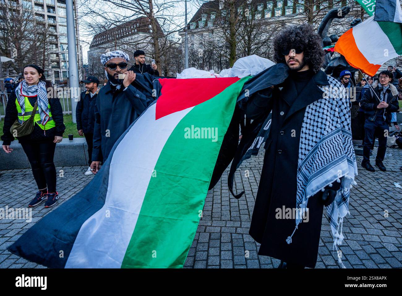 Symbolic corpses are carried aloft on a huge platform, to signify the ...
