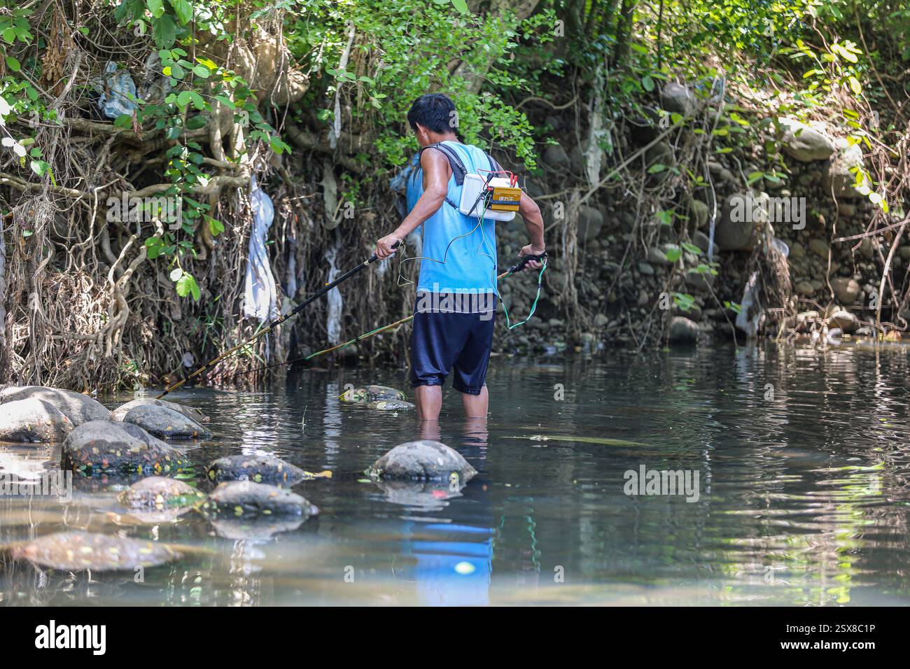 Pampanga, Philippines. Feb 23,2025. A Filipino man practices electric ...