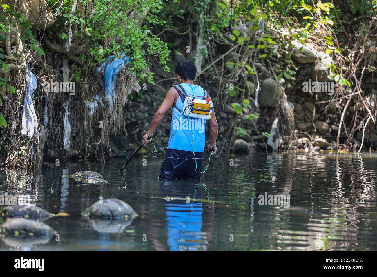 Pampanga, Philippines. Feb 23,2025. A Filipino man practices electric ...
