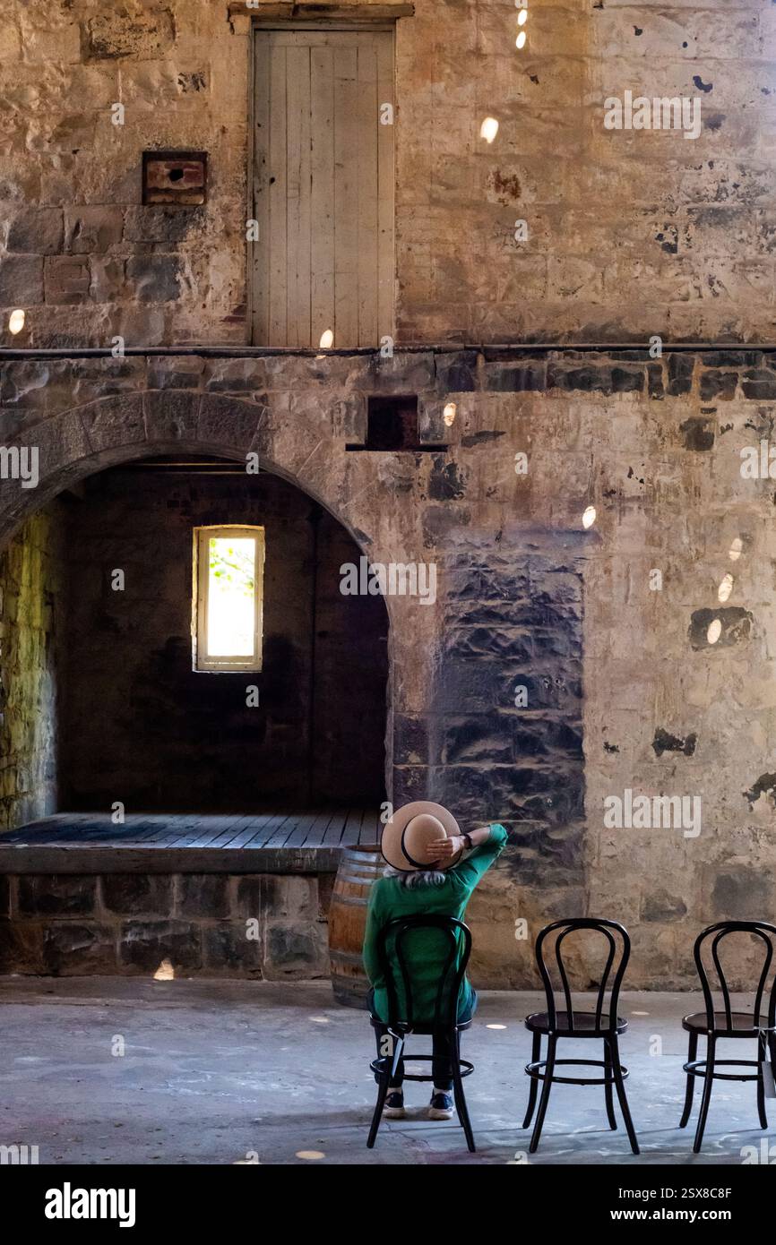Woman seated in an art space in Fyansford Paper Mill Stock Photo - Alamy