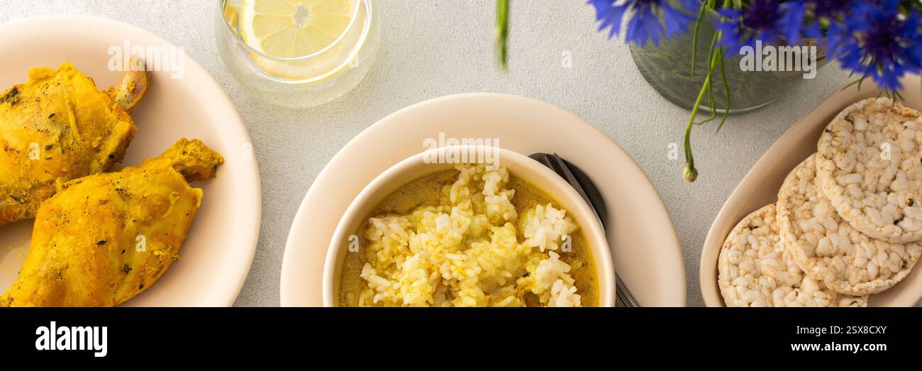 Stewed rabbit with rice, broccoli and rice cakes, a served table with ...