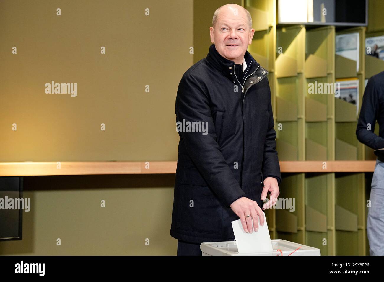 German Chancellor Olaf Scholz casts his vote at a polling station in ...