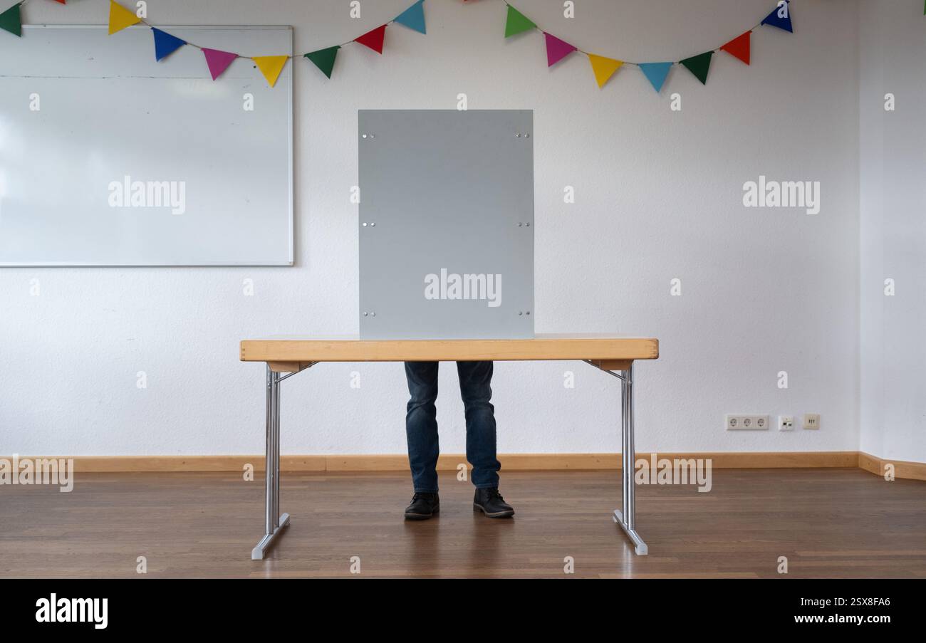 Sigmaringen, Germany. 23rd Feb, 2025. A voter casts his vote at a polling station in the Laiz ...