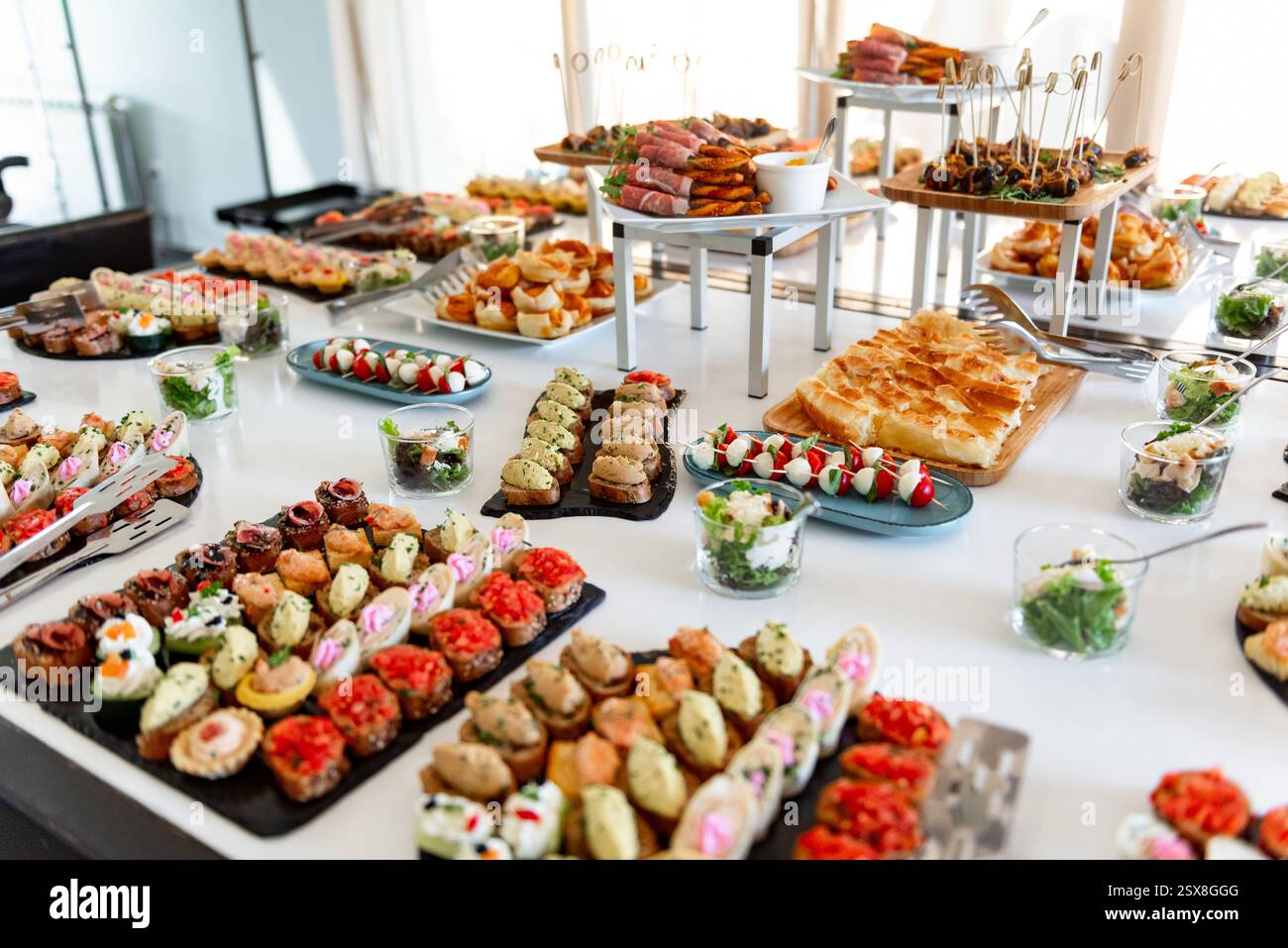 A vibrant assortment of canapes is beautifully arranged on a long table ...