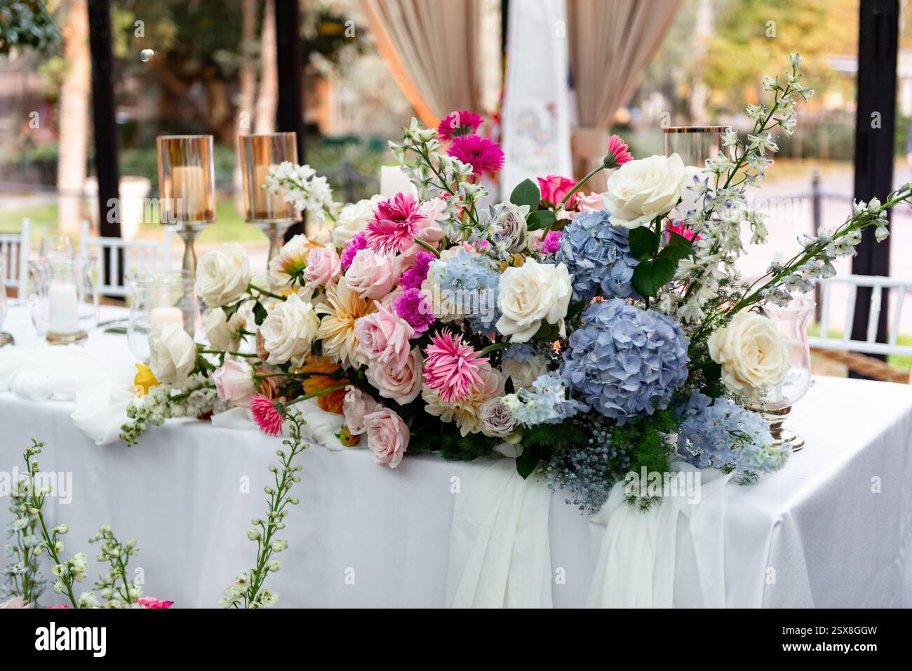 A stunning display of colorful blooms adorns a beautifully set outdoor ...