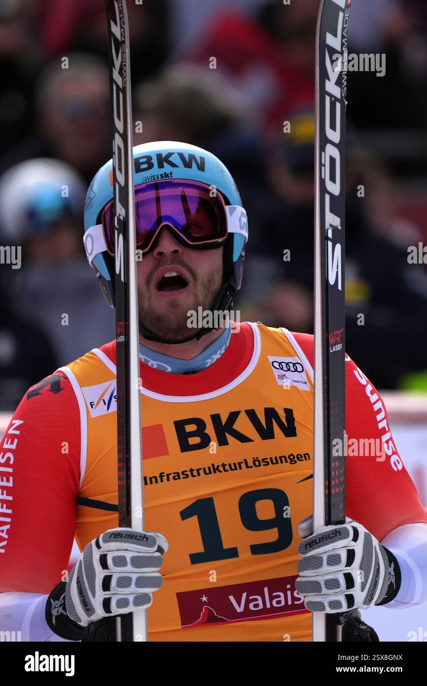 Switzerland's Alexis Monney reacts after completing an alpine ski, men ...