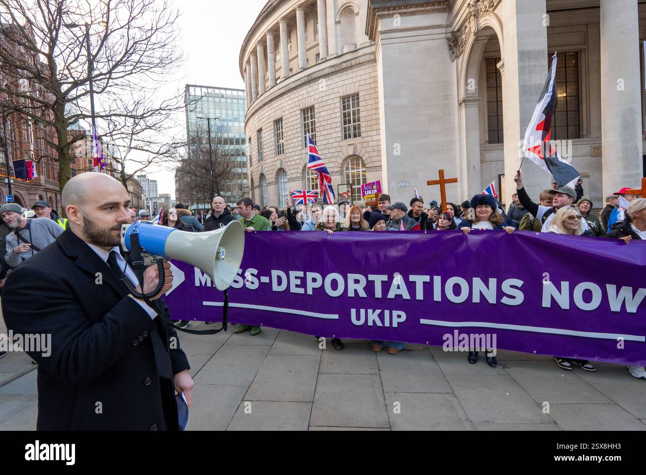 Nick Tenconi gives a speech to supporters before marching with a raised ...