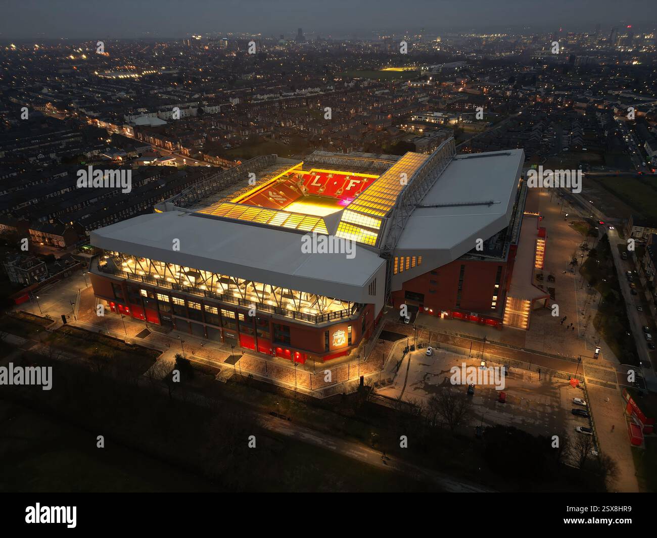 A breathtaking drone shot of Anfield at dusk, with stadium lights ...
