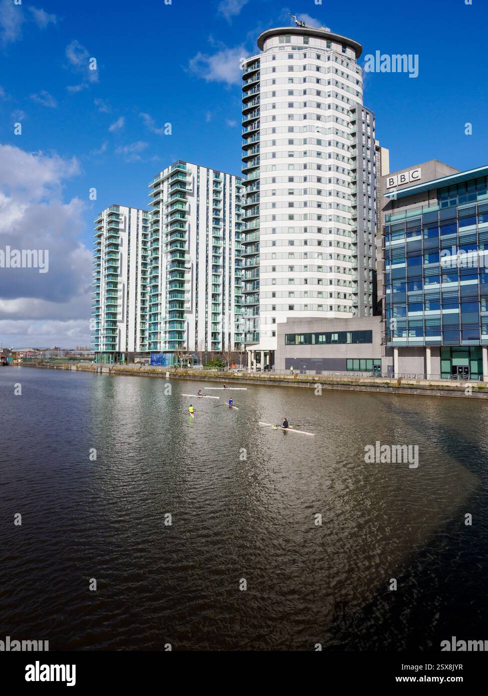 Salford, Manchester, UK, 02-22-2025: People kayaking on a river beside ...
