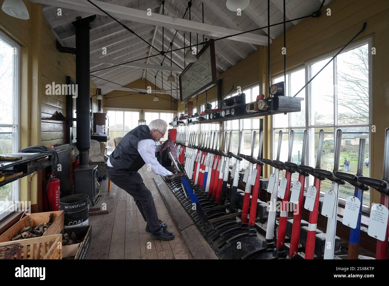 A signaller at work in the signal box at Wansford station as the Flying ...