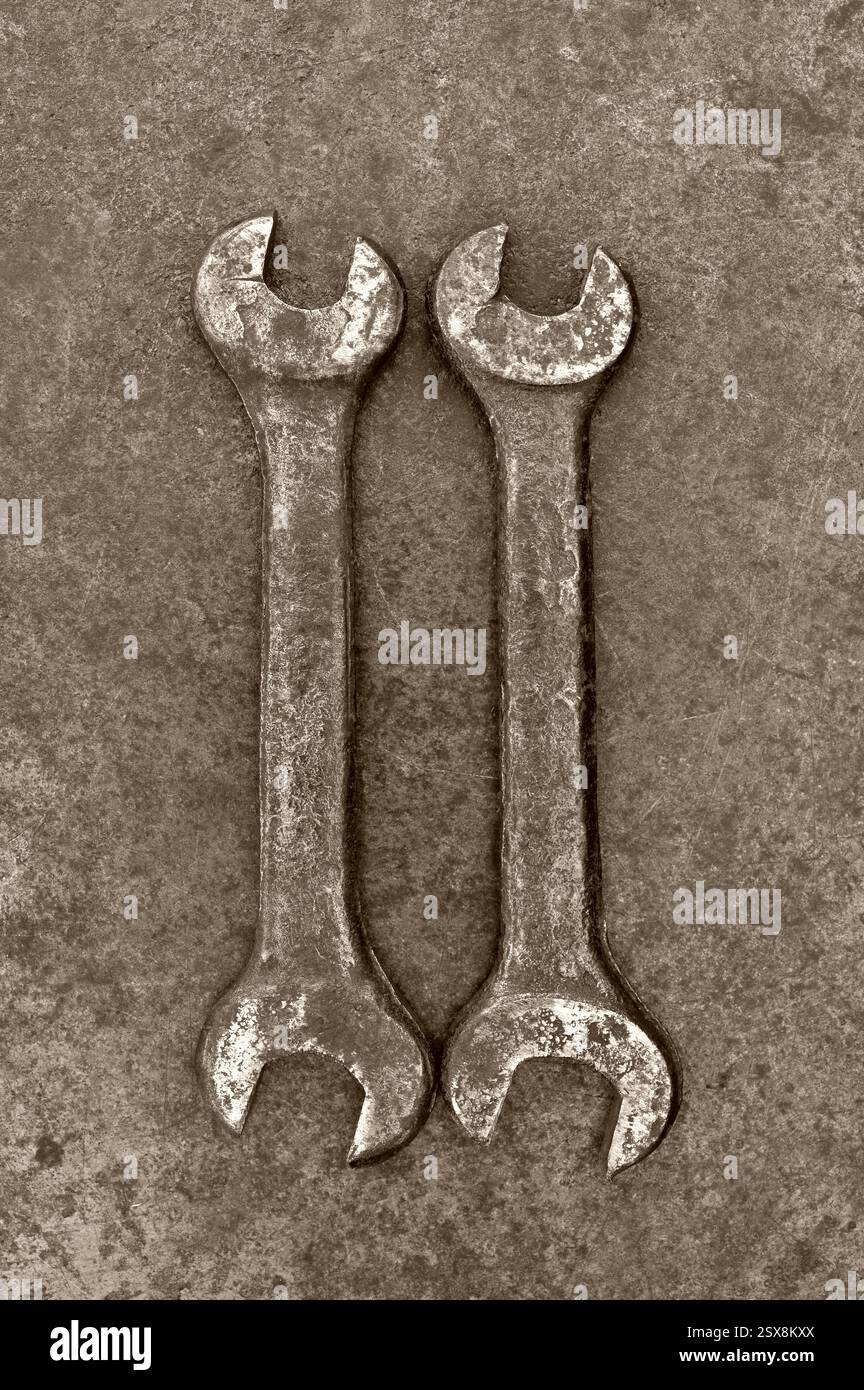 One large and one small rusty spanners lying on tarnished metal Stock ...