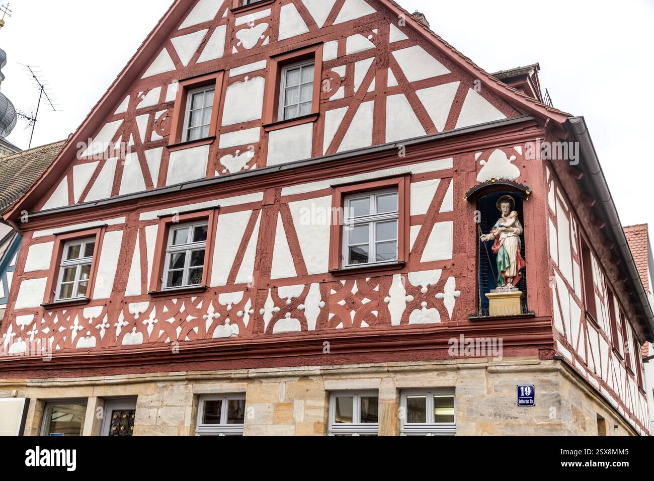 A half-timbered building in Germany displays a statue of the Virgin ...