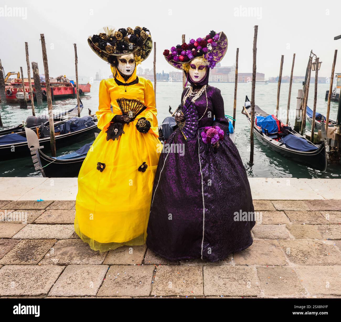 Venice, Italy. 23 February 2025 Revellers in colourful costumes ...