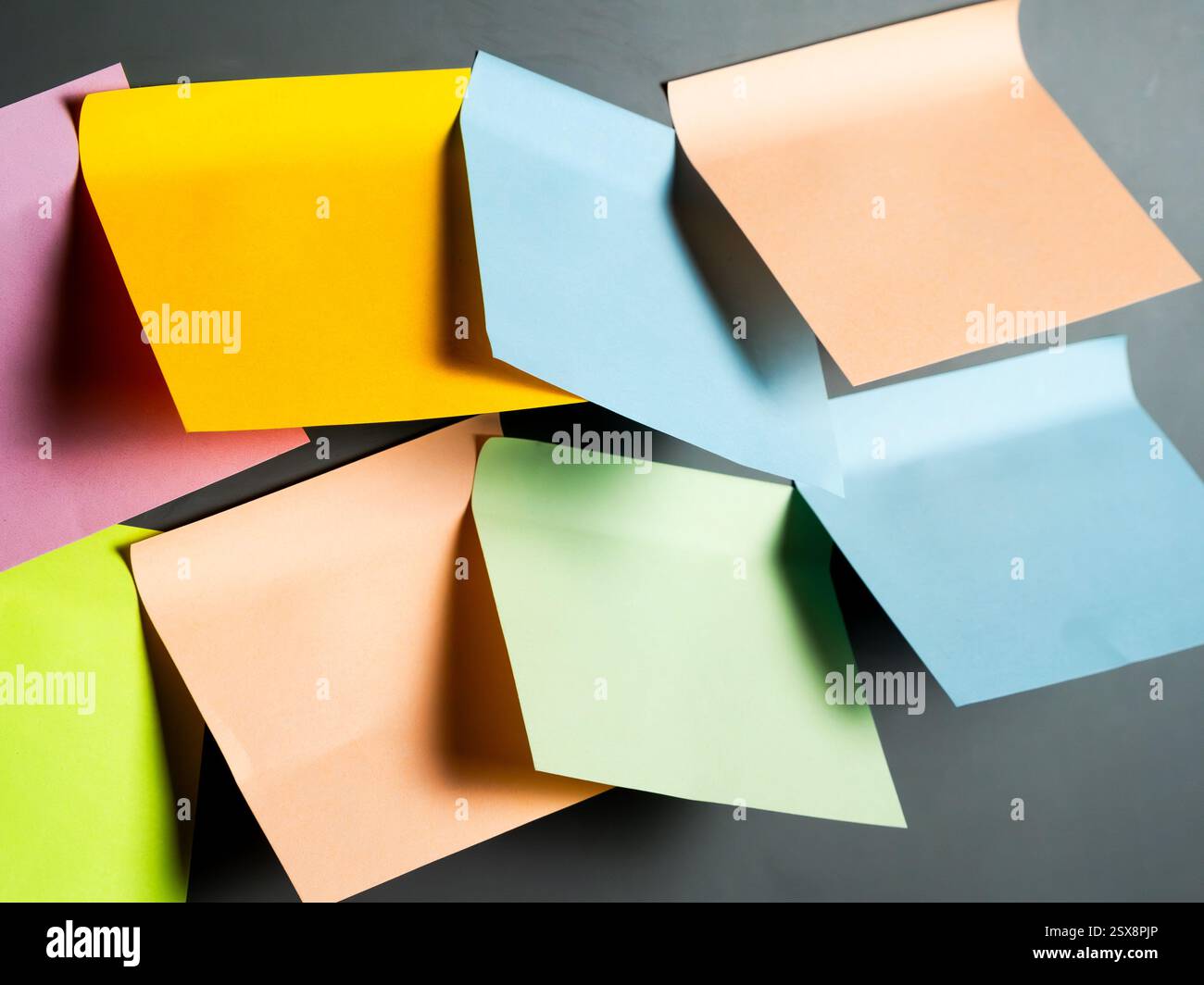 Brightly colored sticky notes are placed on a dark background ...
