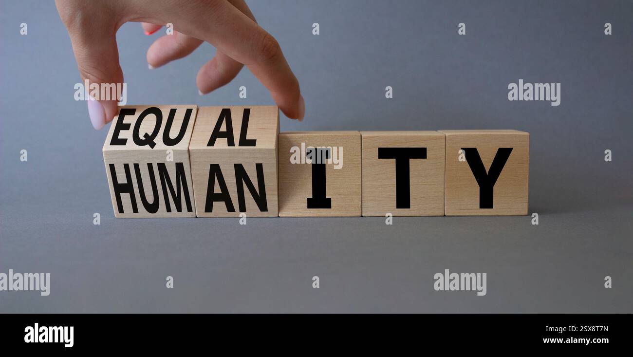 Equality and Humanity symbol. Businessman hand. Turned cubes with words ...