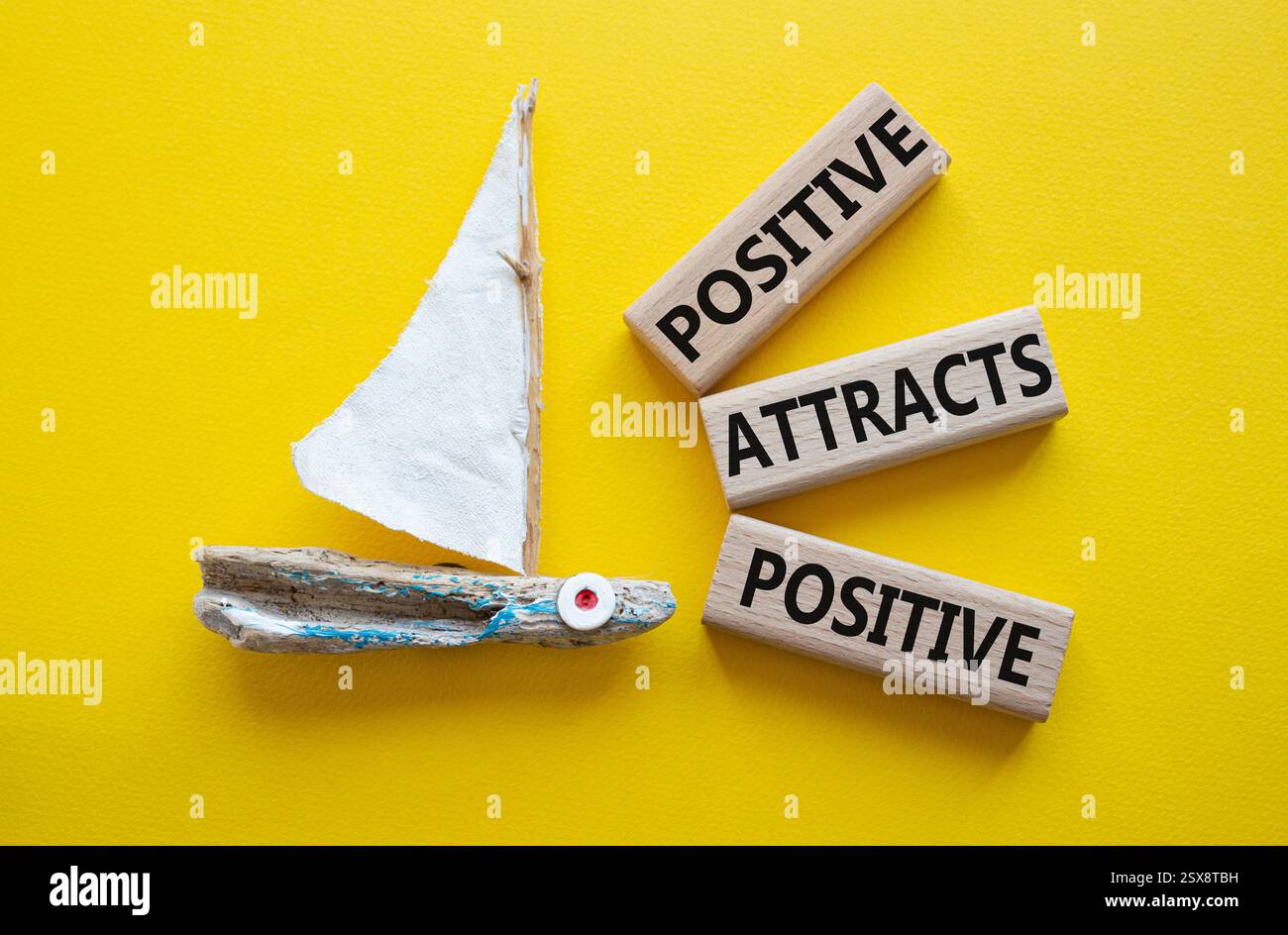 Positive attracts Positive symbol. Wooden blocks with words Positive ...