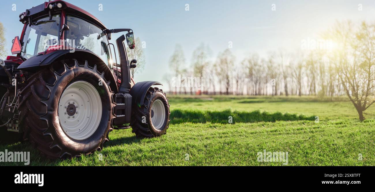 A red tractor stands on green grass, plowing, farming life, land ...